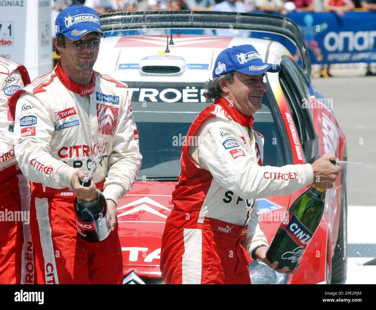 France's Sebastien Loeb, left, celebrates his win of the Acropolis ...