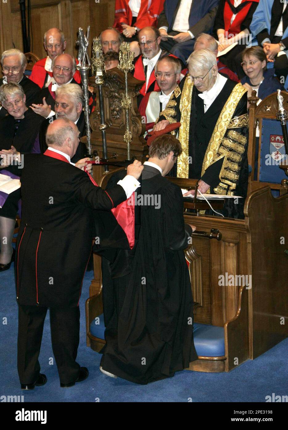 Britain's Prince William, kneeling, during his graduation ceremony at ...