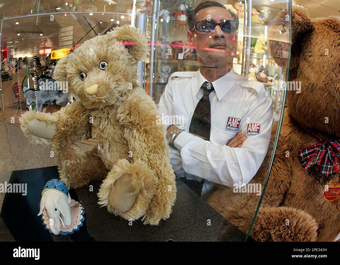Security guard Karim Tofan watches over a new Steiff teddy bear in ...