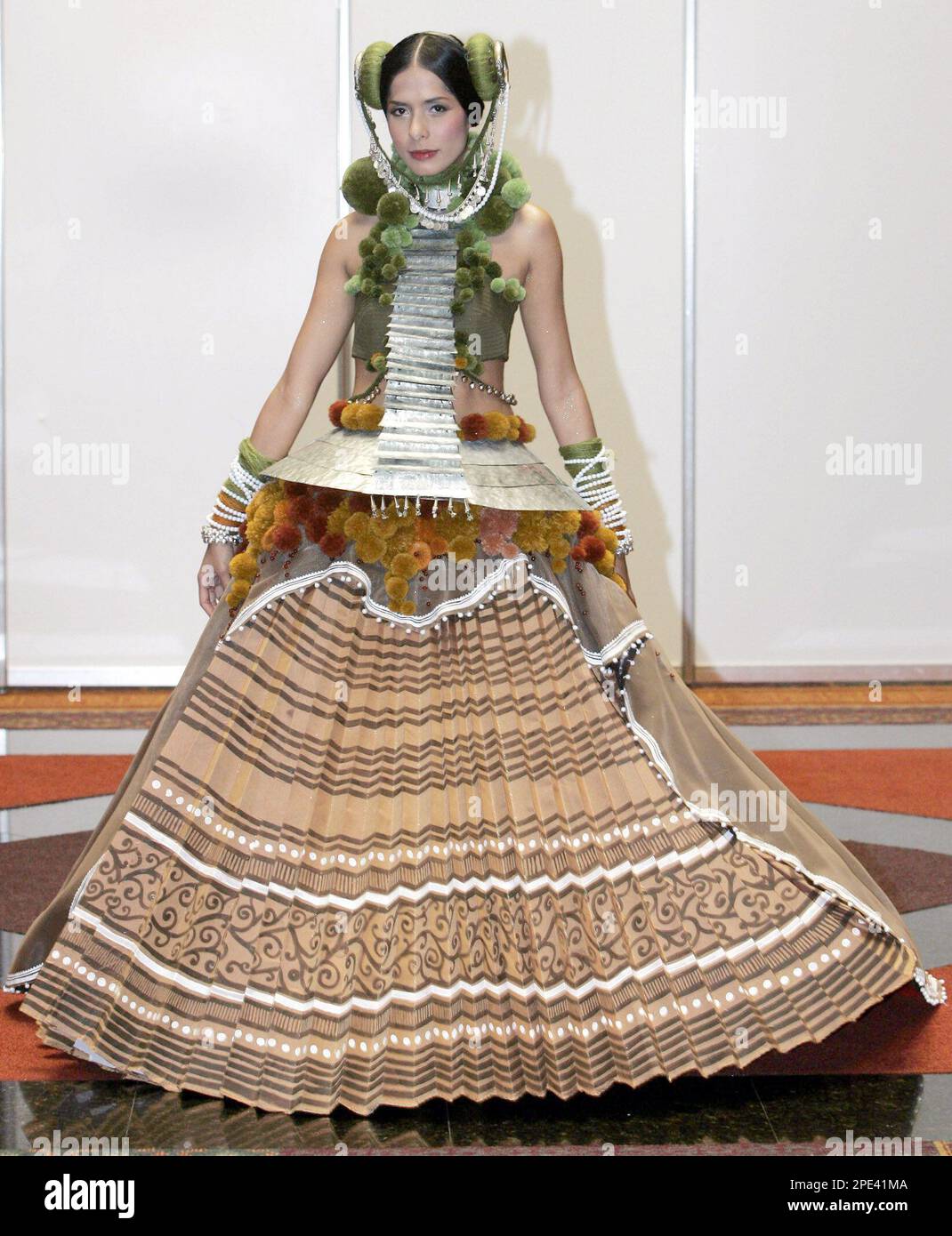 A Thai model poses on catwalk, wearing attire designed by Sarun ...