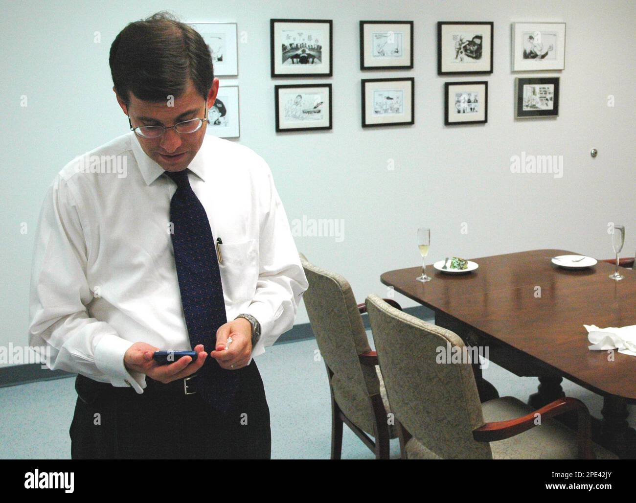 U.S. Circuit Judge William H. Pryor checks e-mail on a handheld device ...