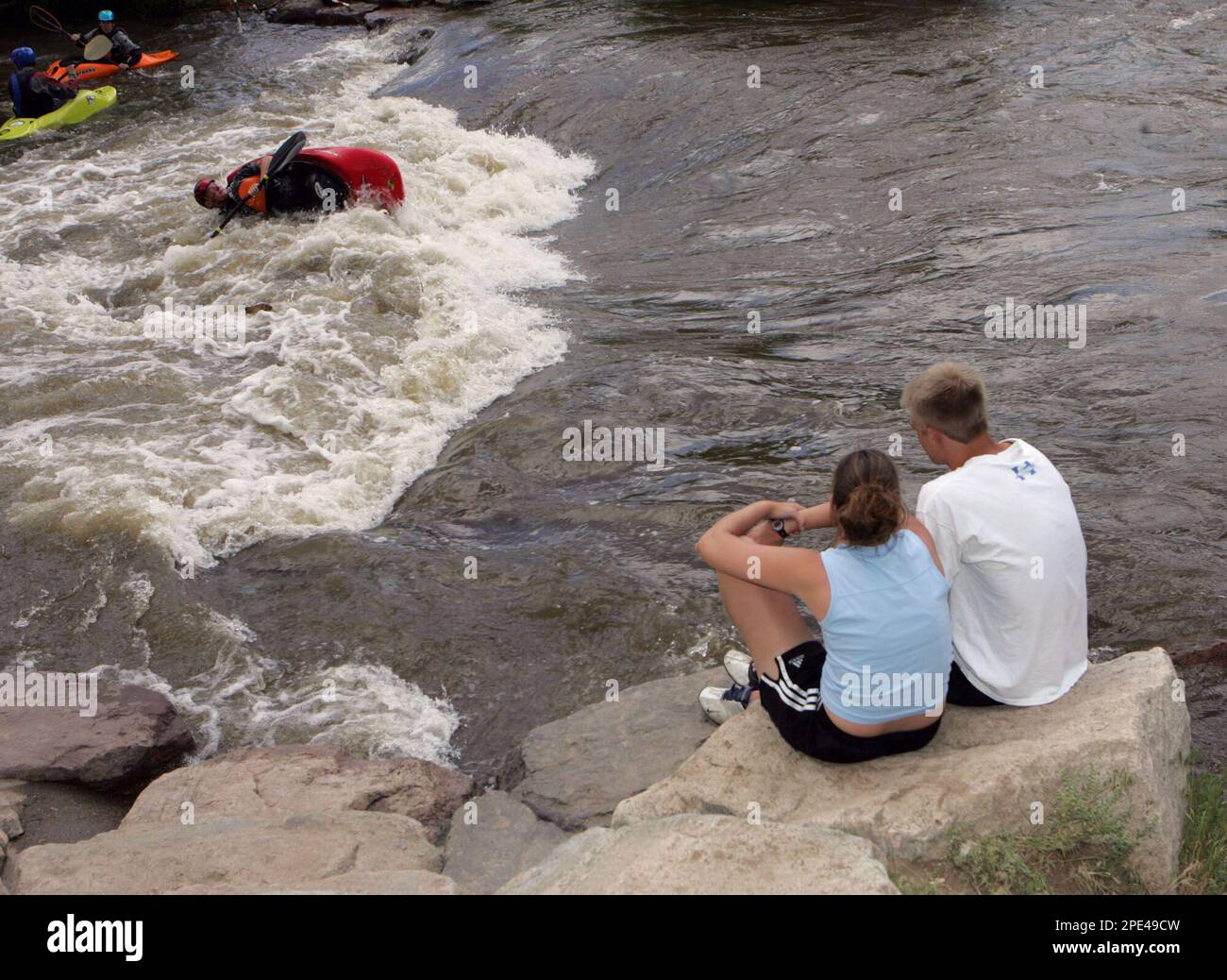 An unidentified couple looks on as Mathew Ryan of Denver flips over on ...