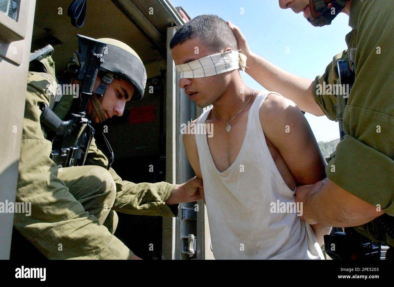 Israeli soldiers put blindfolded Palestinian ThayerAbu Assab, 20, into ...
