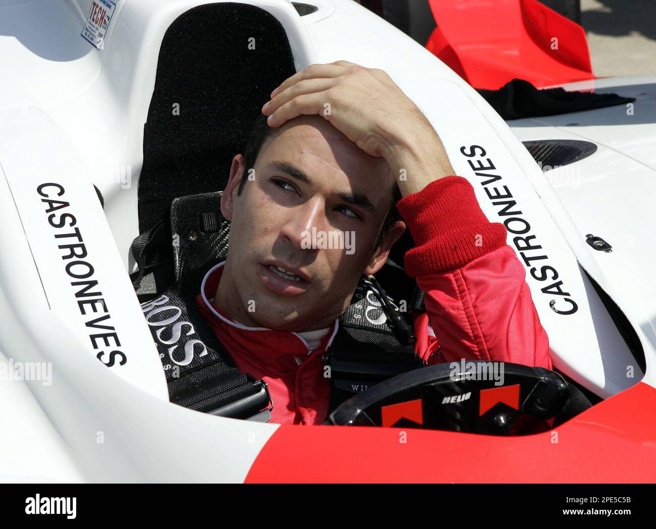 Indy Racing League driver Helio Castroneves of Brazil sits in his car ...