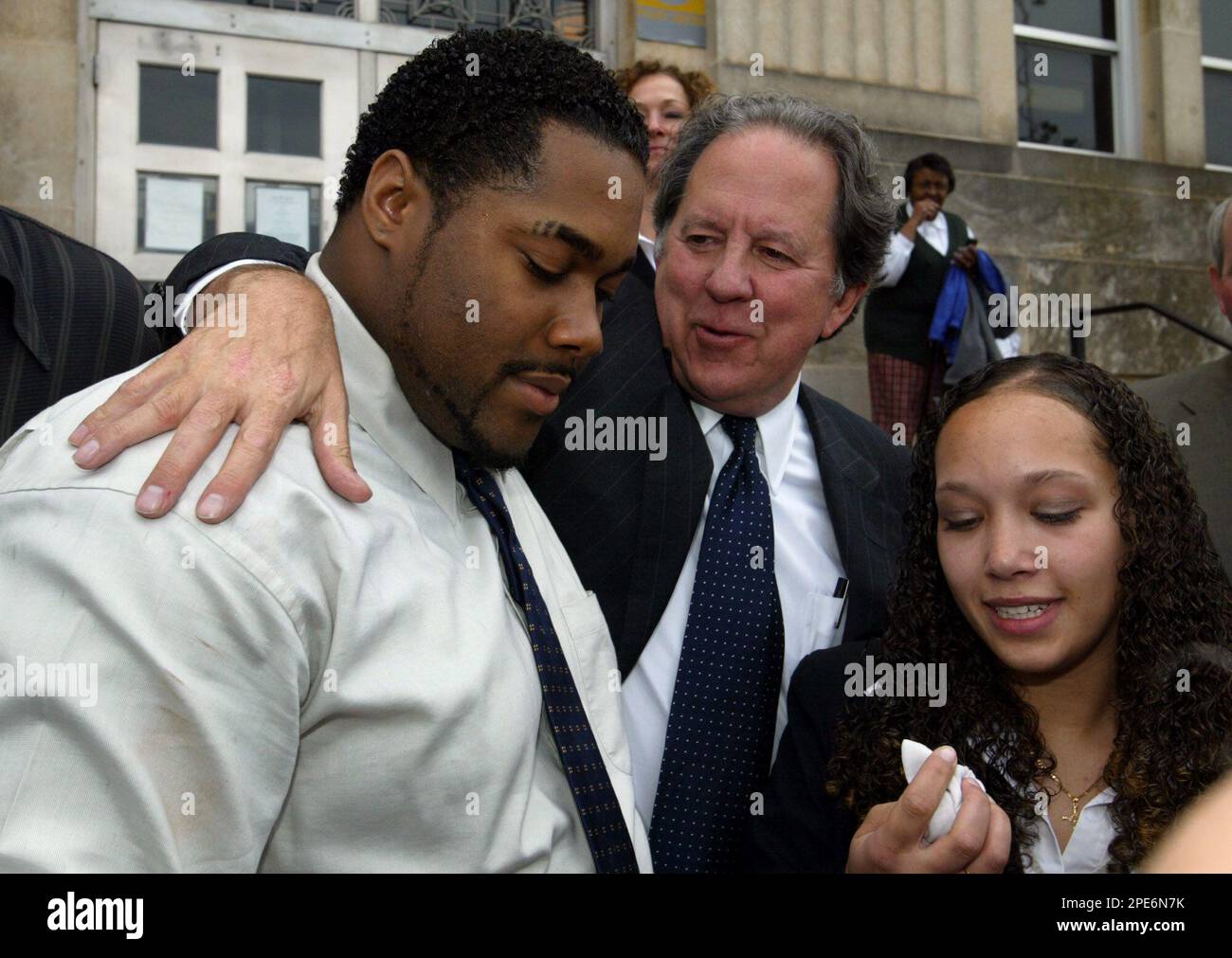 Former Nebraska football player Darren DeLone, left, gets a hug from ...
