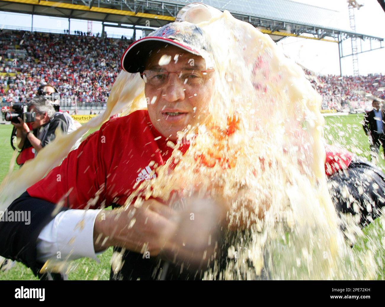 Bayern Munich's headcoach Felix Magath is showered with beer as he and ...