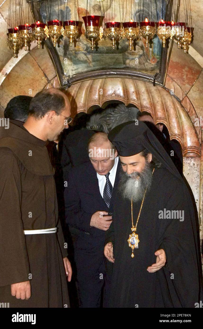 Russian President Vladimir Putin, center, visits the Church of the Holy ...