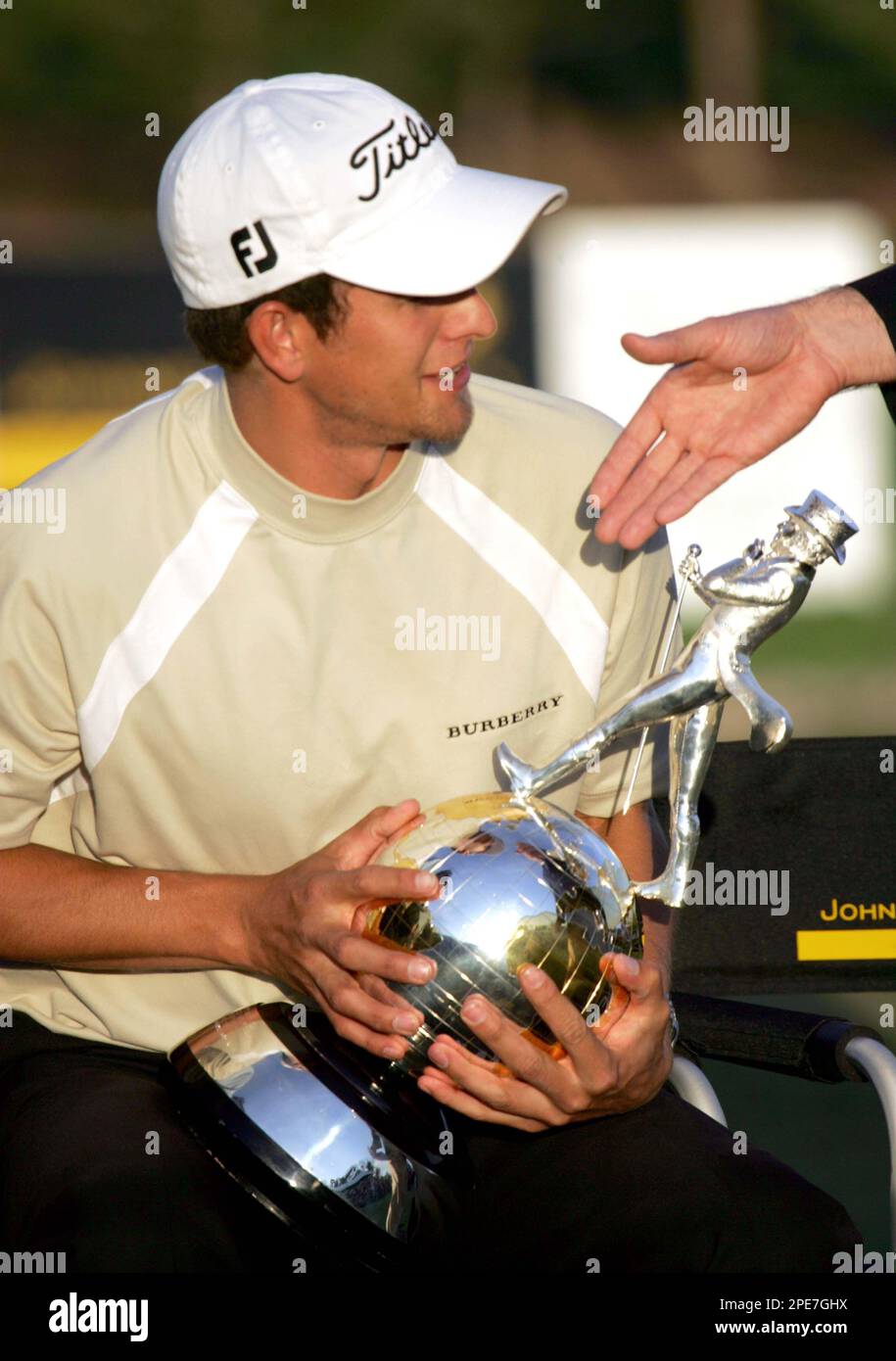 Australia's Adam Scott kisses is offered a congratulatory handshake as ...
