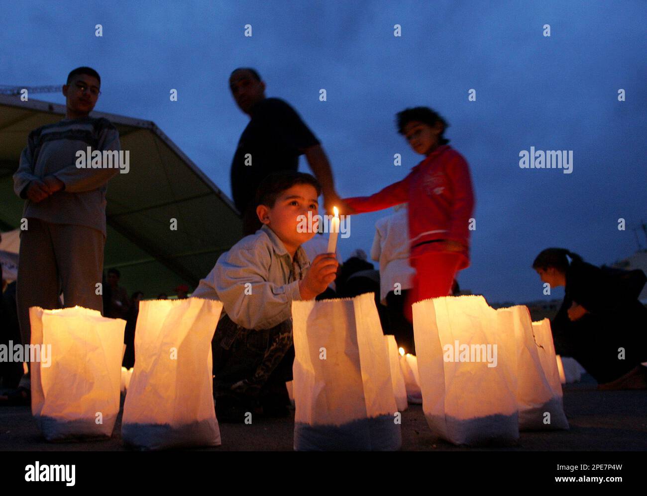A Lebanese boy holds a candle in downtown Beirut, Lebanon, Thursday ...
