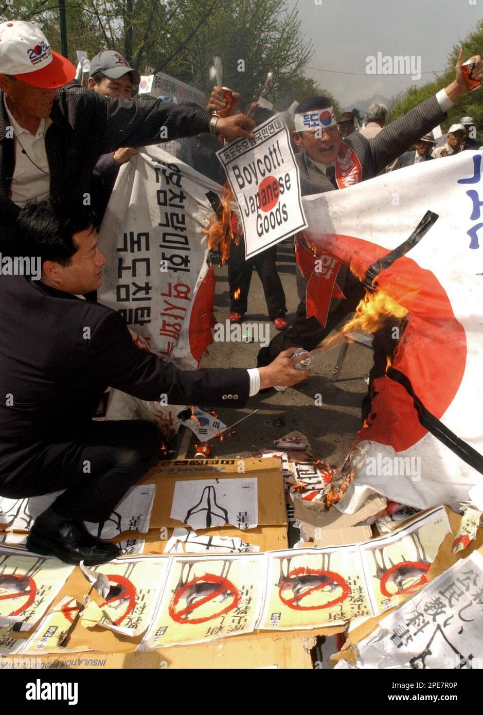 South Korean protesters burn a Japanese flag during an anti-Japan rally ...