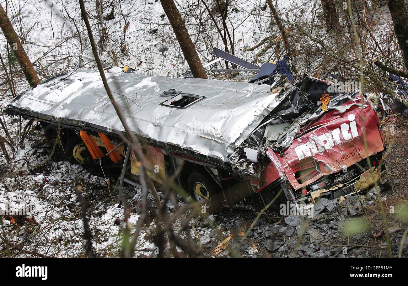 A Swiss tour bus lays on the bank of the Dranse river after an accident ...