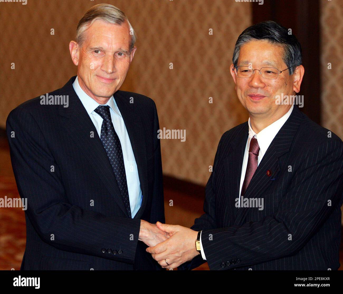 Dutch Foreign Minister Bernard Bot, left, is greeted by his Japanese counterpart Nobutaka ...