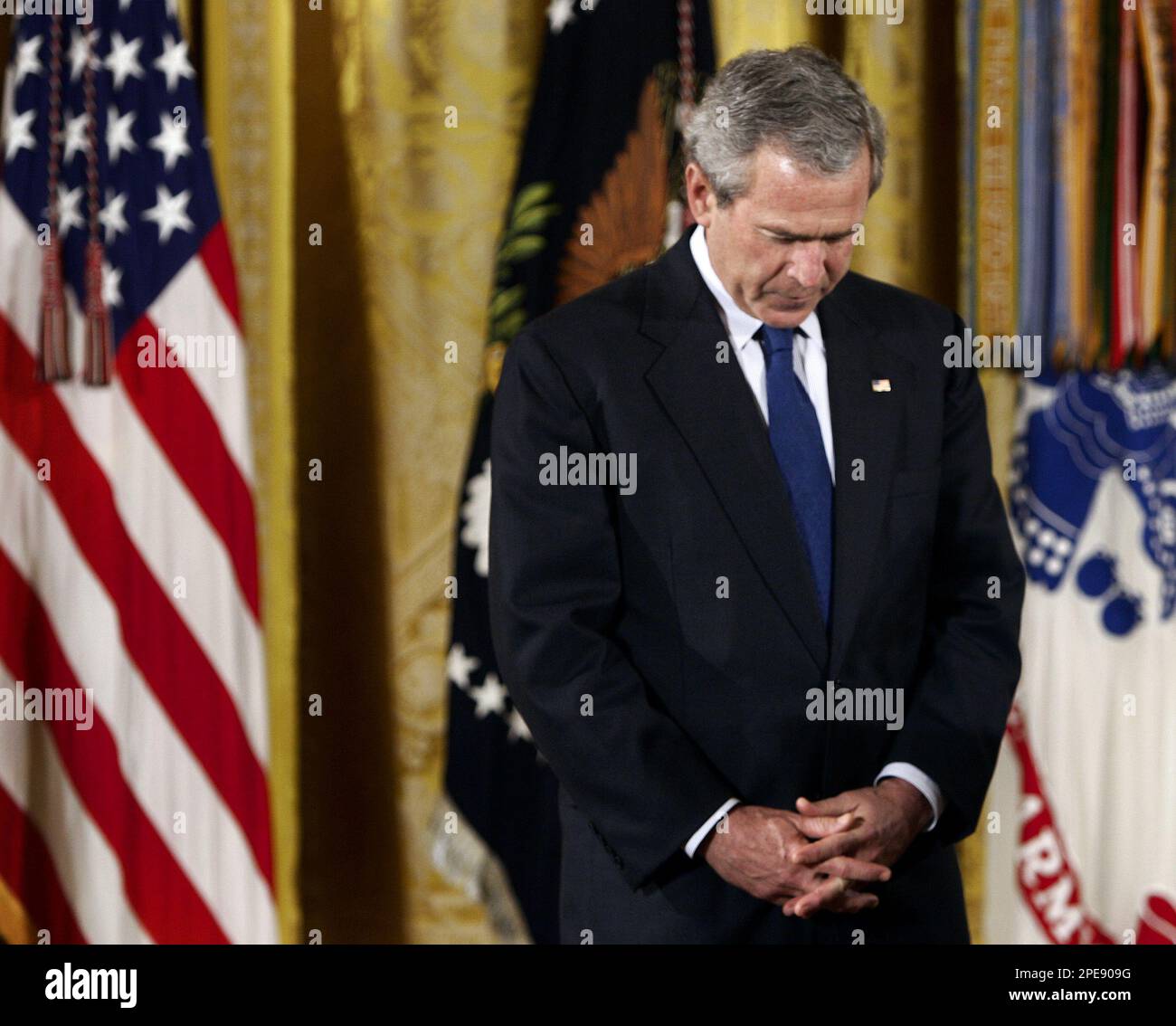 President Bush bows his head during the invocation at a Medal of Honor ...