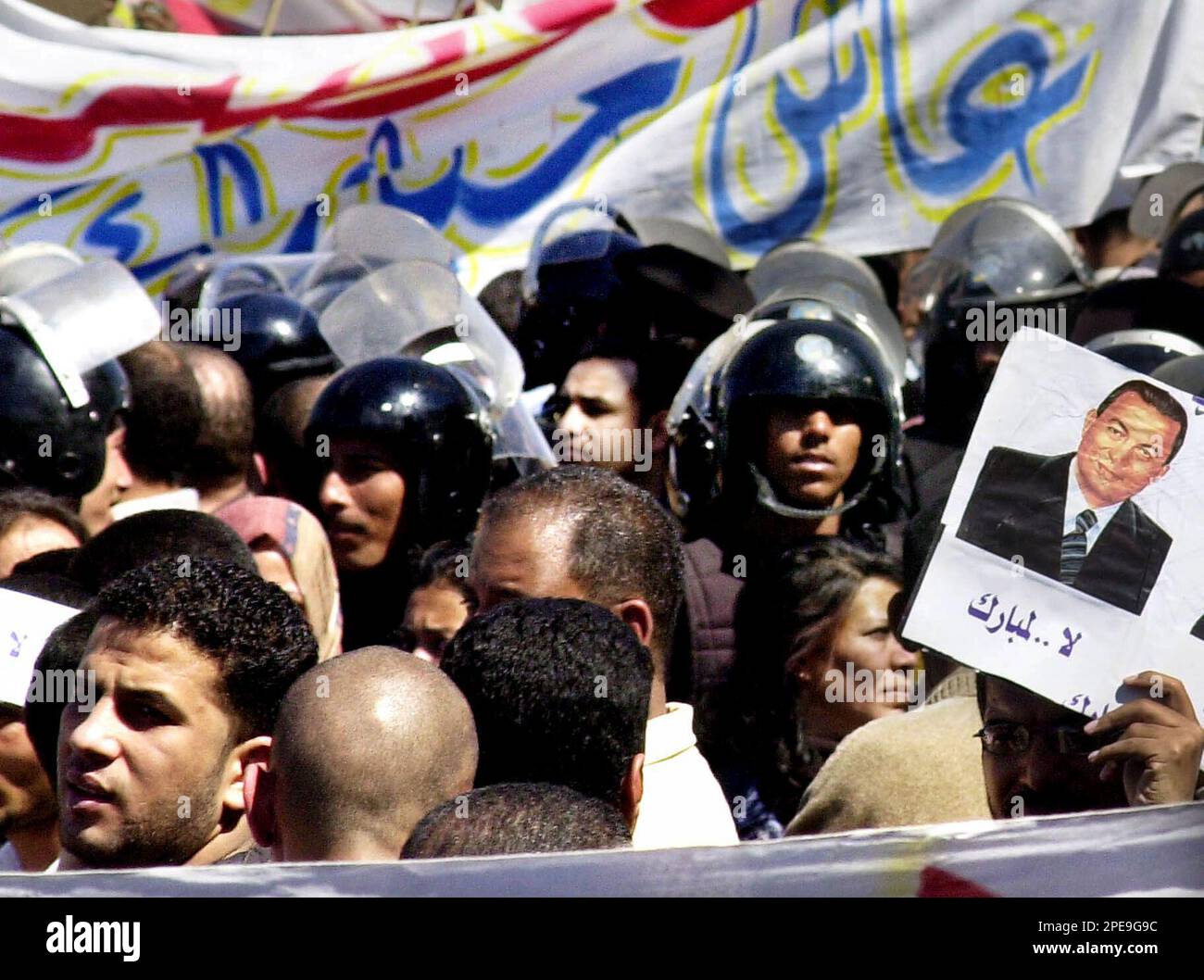 Egyptian riot police keep a close watch standing between demonstrators ...