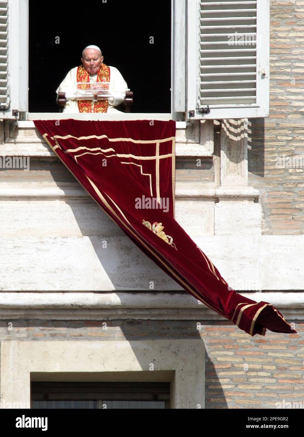 Wind blows the drape below Pope John Paul II's window as he looks out ...