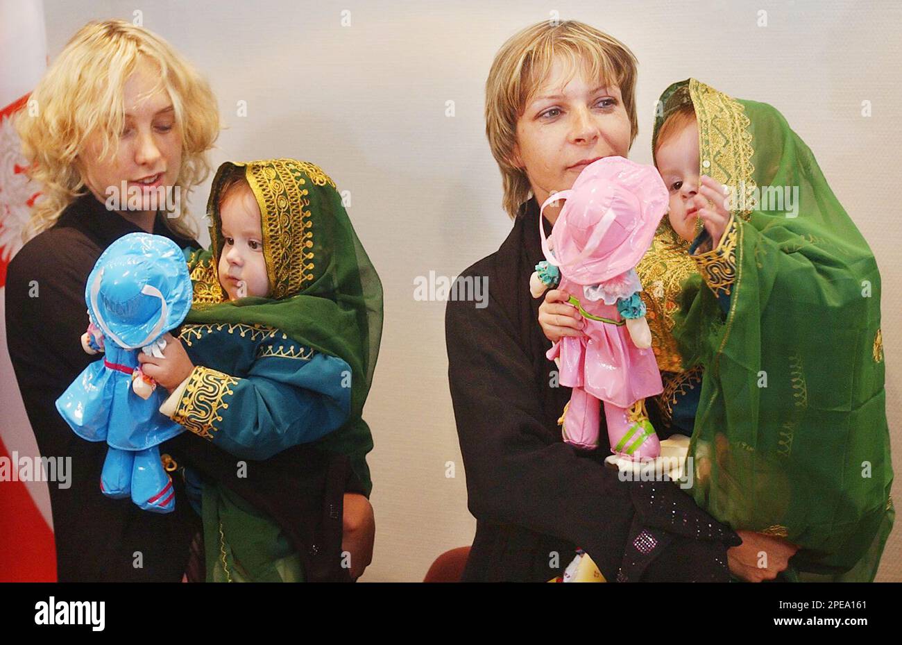 Twin Polish girls Olga, second left, and Daria Kolacz, right, dressed ...