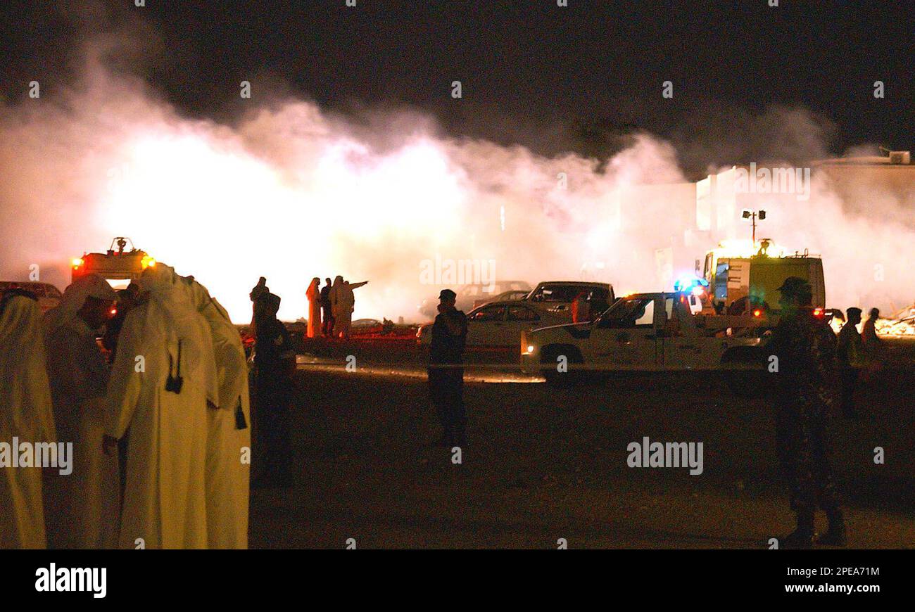 Security officials and rescue workers inspect the scene near the Doha ...