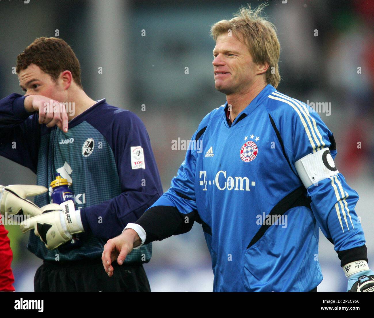Munich's goalkeeper Oliver Kahn, right, smiles as he leaves the field ...