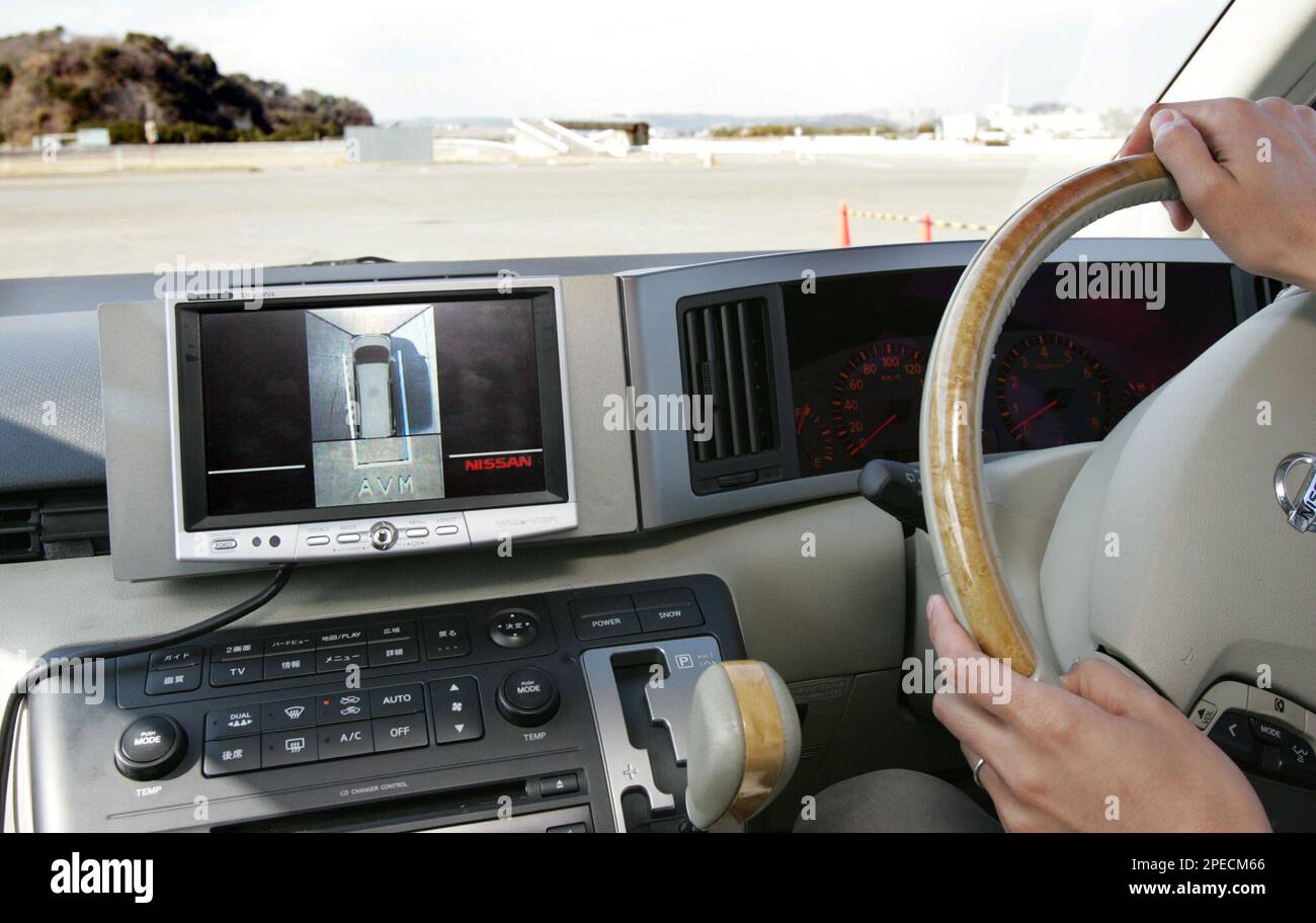 A driver turns the steering wheel to park the car into a right spot ...