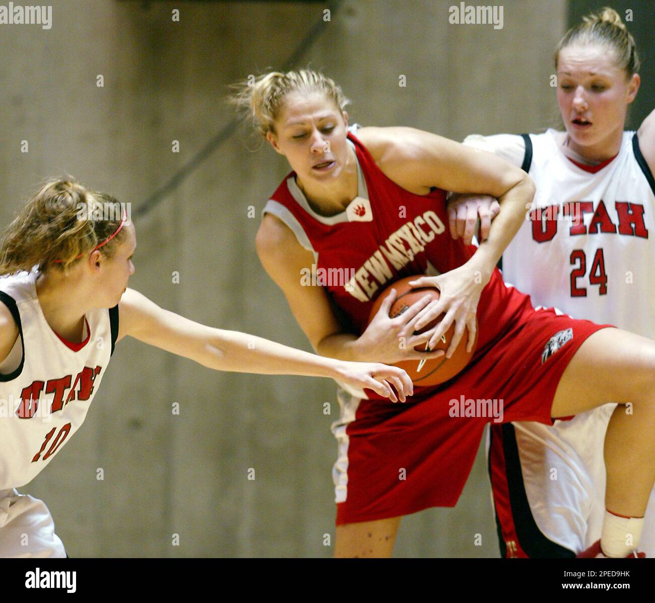 New Mexico center Jana Francis, center, pulls down a rebound against ...