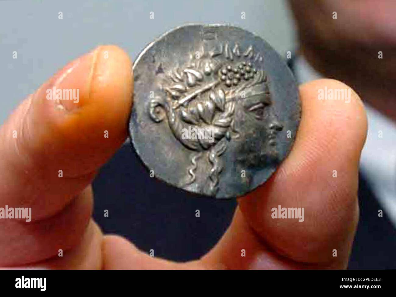 A police officer shows a coin depicting the ancient Greek mythological ...