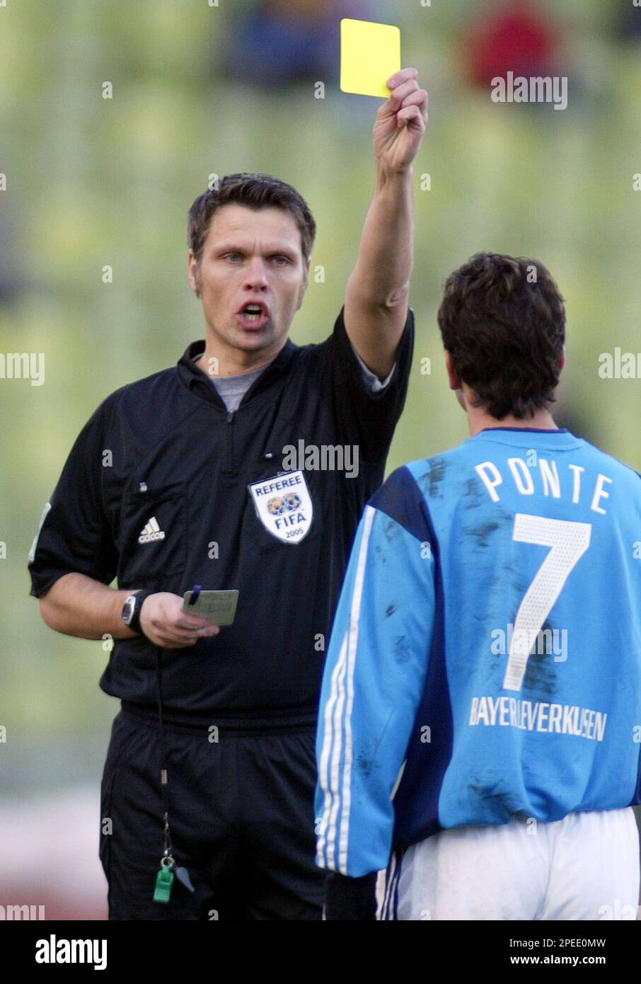 Referee Michael Weiner shows the yellow card to Leverkusen's Robson ...