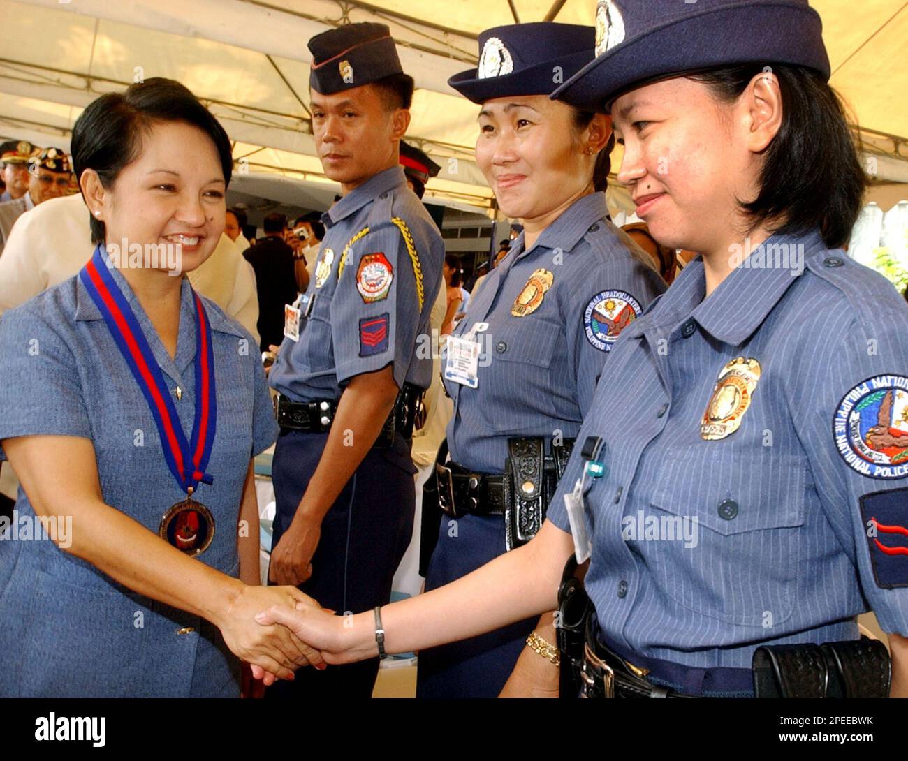 Philippine President Gloria Macapagal Arroyo, left, greets police ...