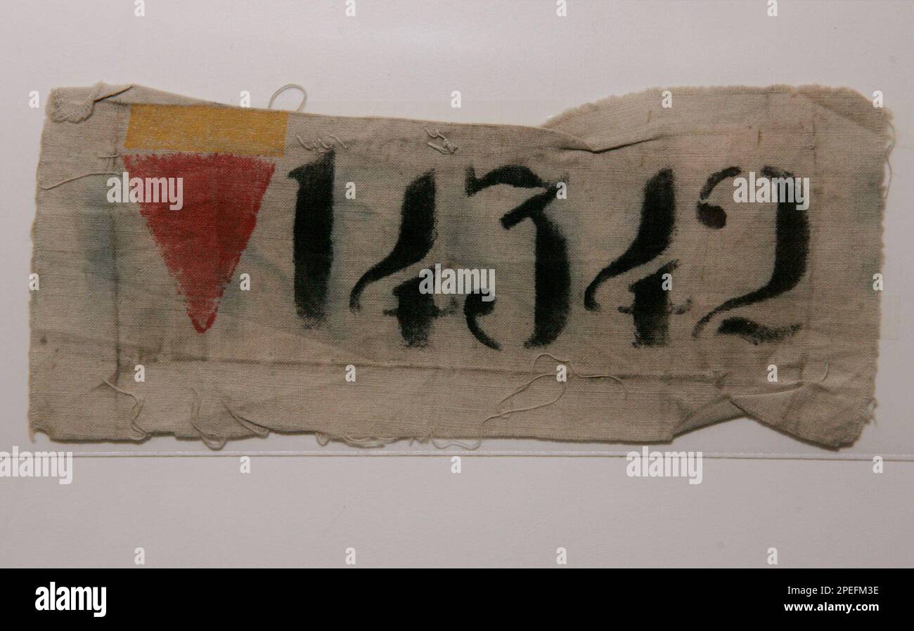 This numbered piece of fabric was worn in a concentration camp by Saul ...