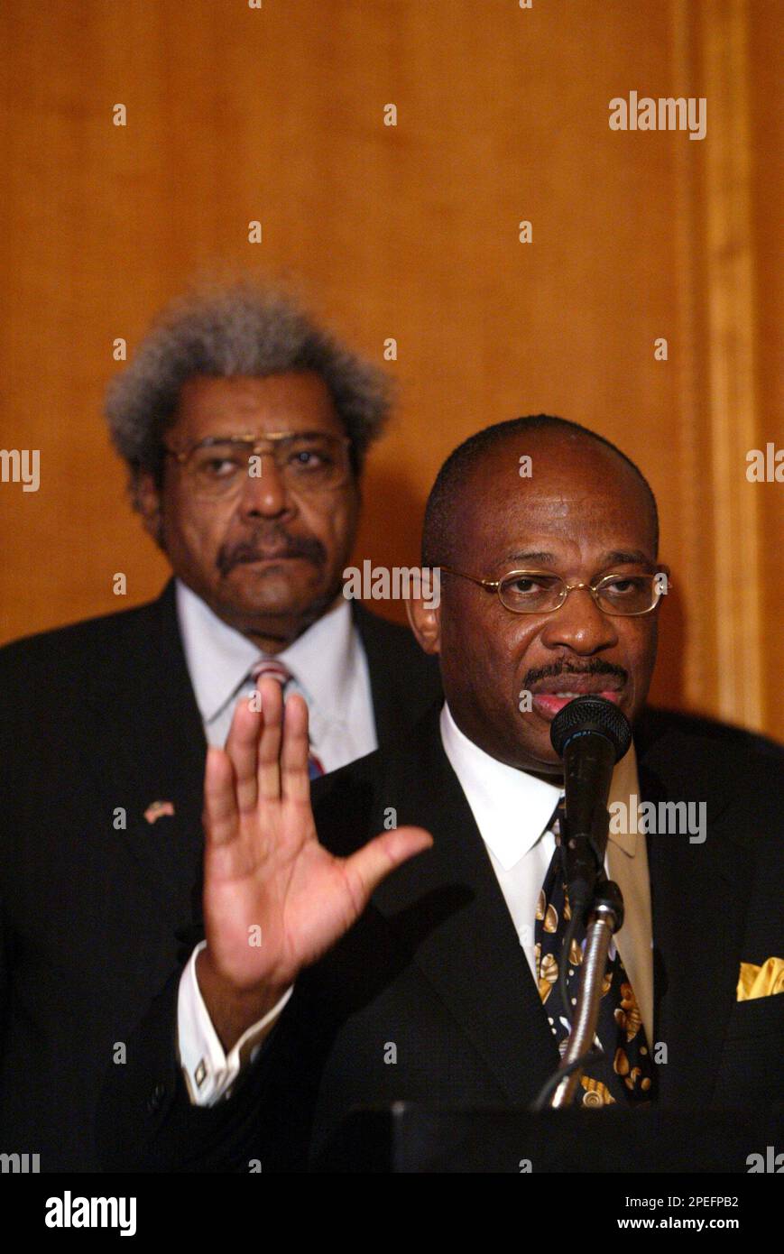 Boxing promoter Don King, rear, looks on as his attorney, Willie Gary ...