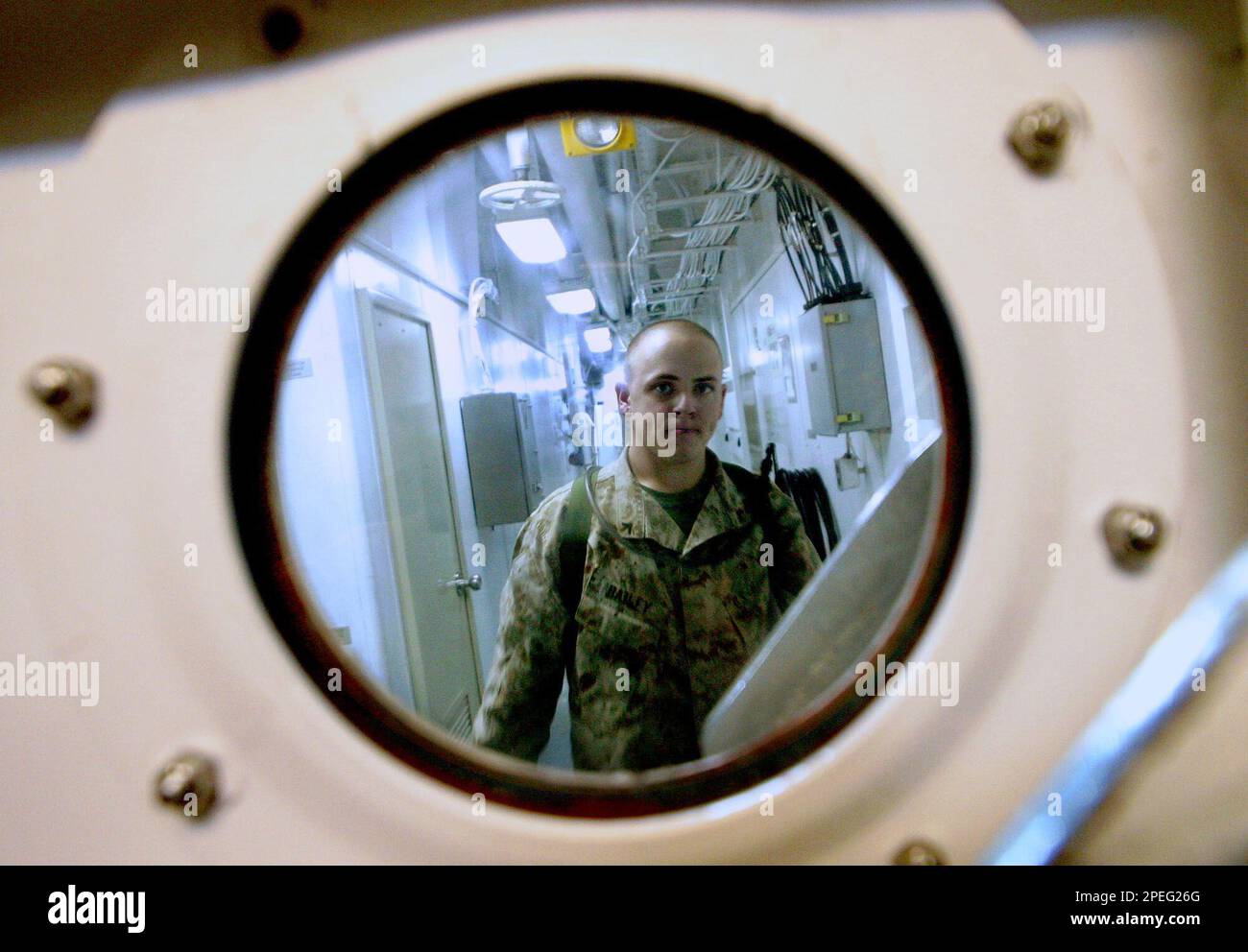 A U.S. Marine Lance Cpl. Erickson is seen through the window of a water ...