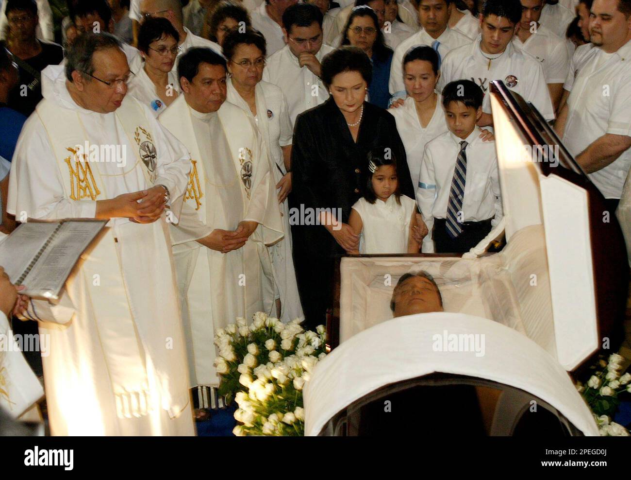 Catholic priests and relatives led by actress Susan Roces (in black dress), widow of former ...