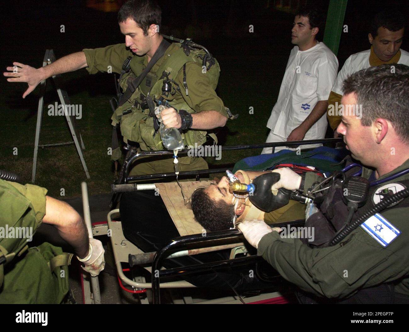 Israeli army medics carry a wounded Israeli soldier, who was injured ...