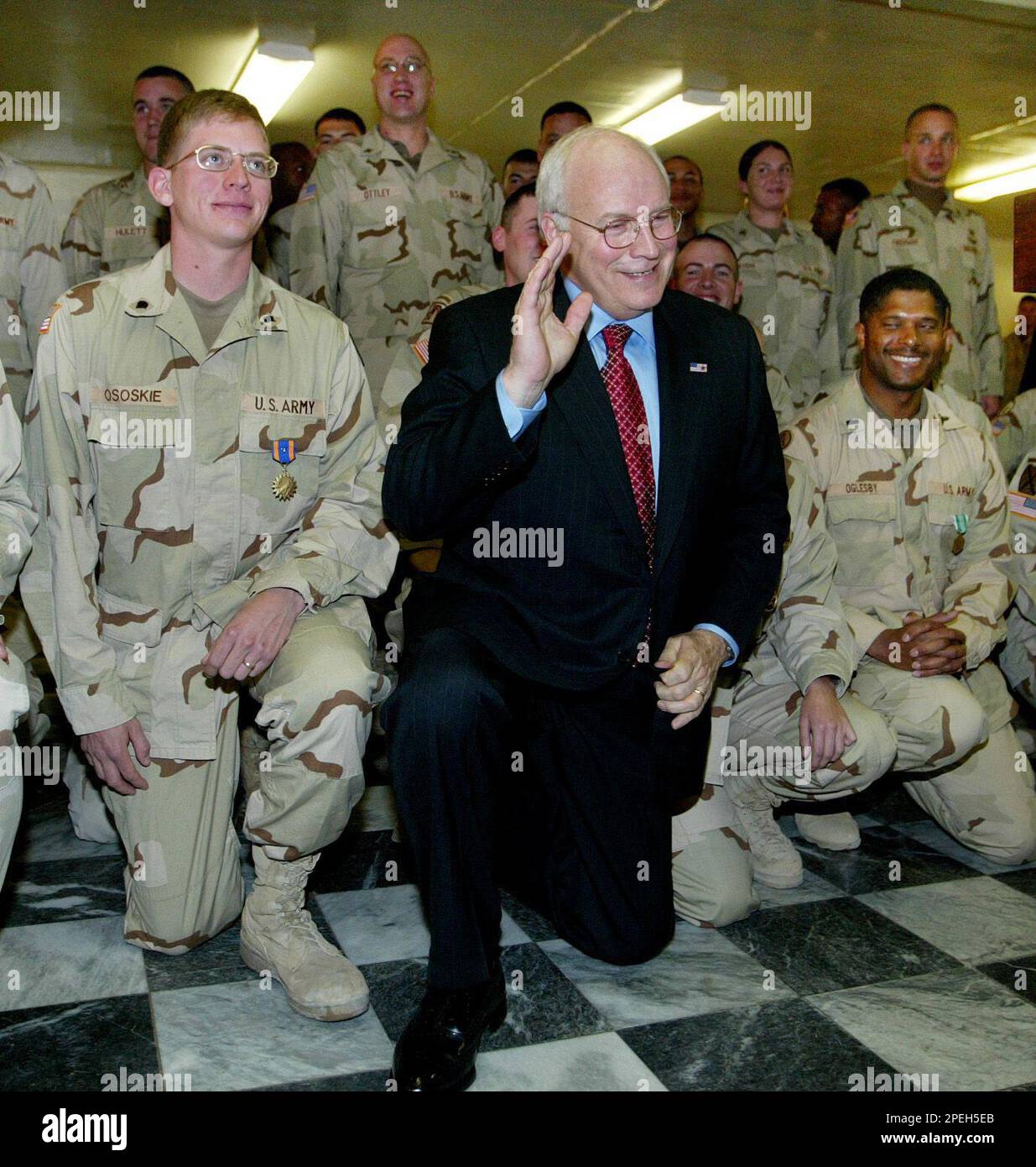 Vice President Cheney takes a knee during a photo session Tuesday Dec ...