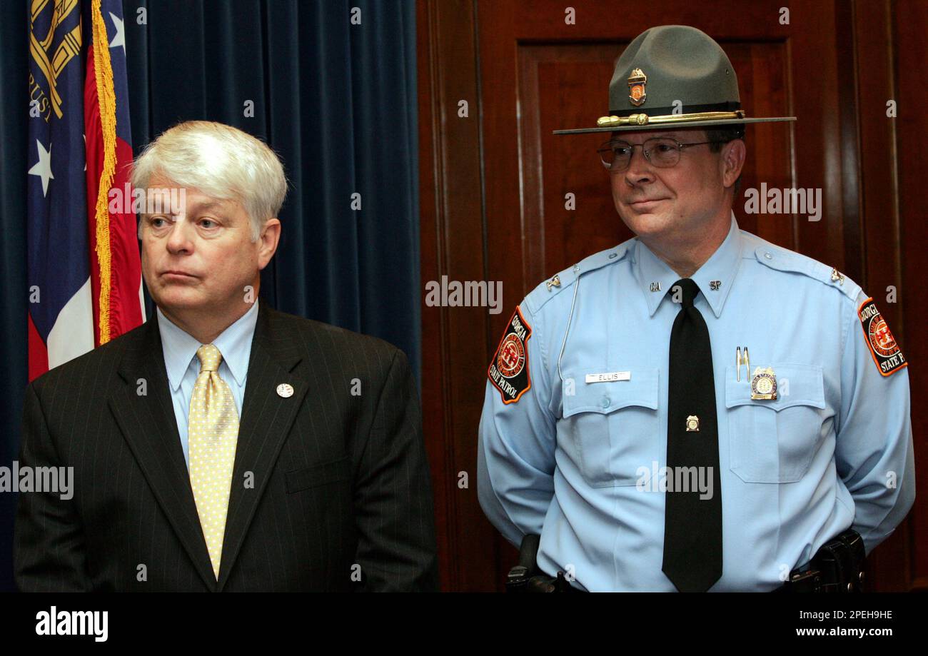 Bill Hitchens, left, looks on as Gov. Sonny Perdue, not shown ...