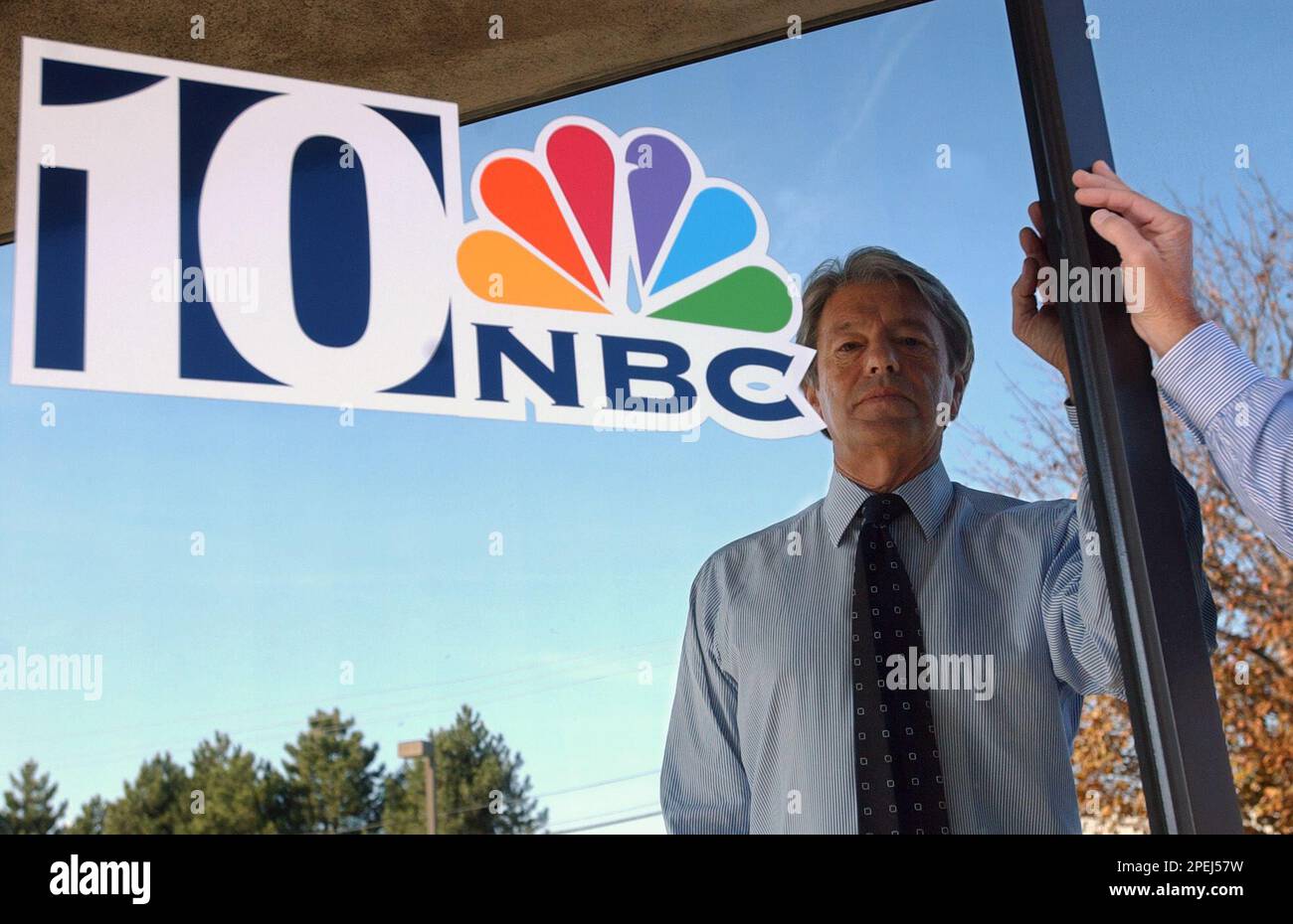 WJAR-TV news reporter Jim Taricani is seen in a reflection of the ...