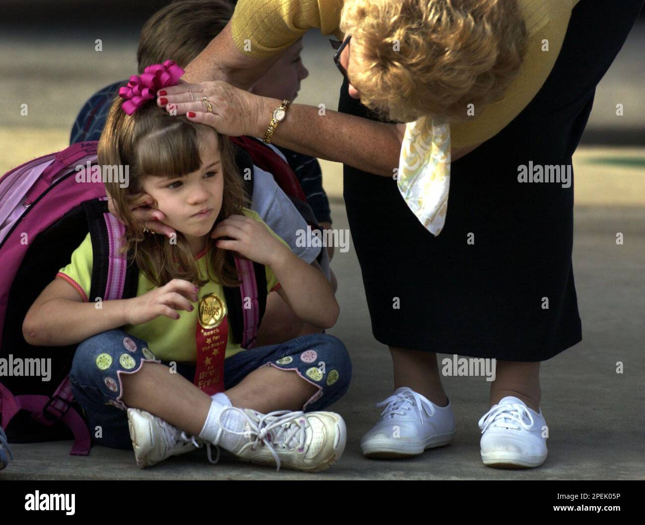 Patterson Elementary School teacher's aide Sue Price, right, examines ...