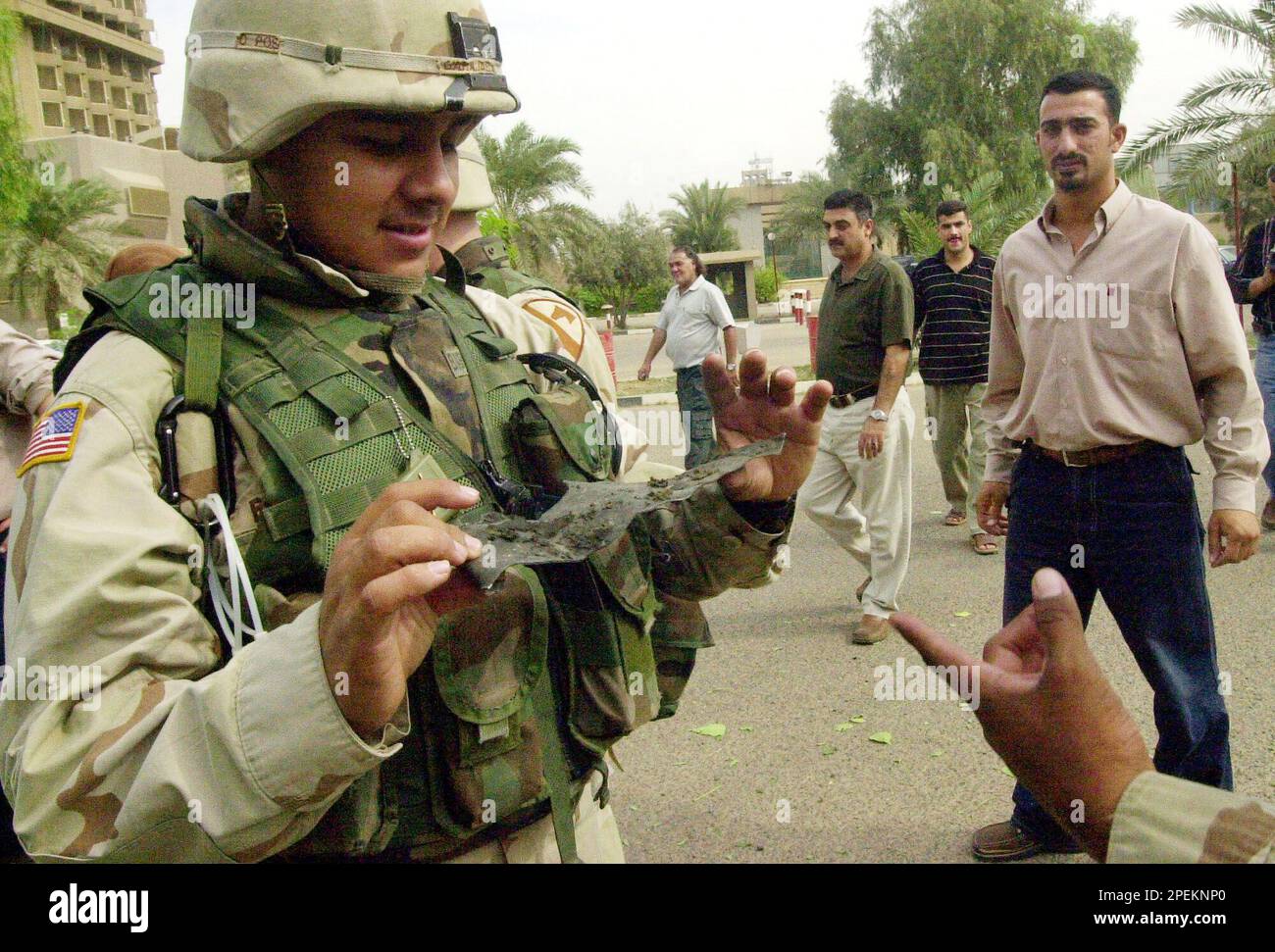 A US soldier looks at a piece of shrapnel after a mortar round hit the ...