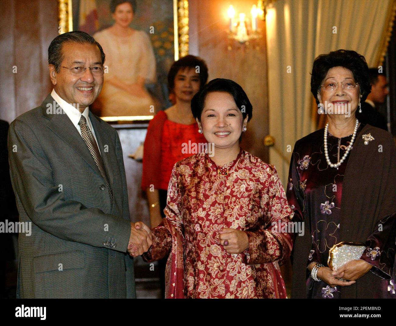 Philippine President Gloria Macapagal Arroyo, center, welcomes former ...