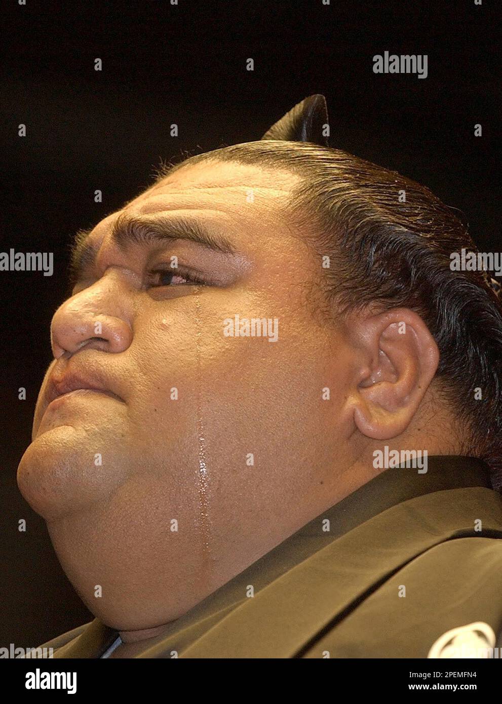 Former grand champion Musashimaru sheds a tear just after his top knot ...