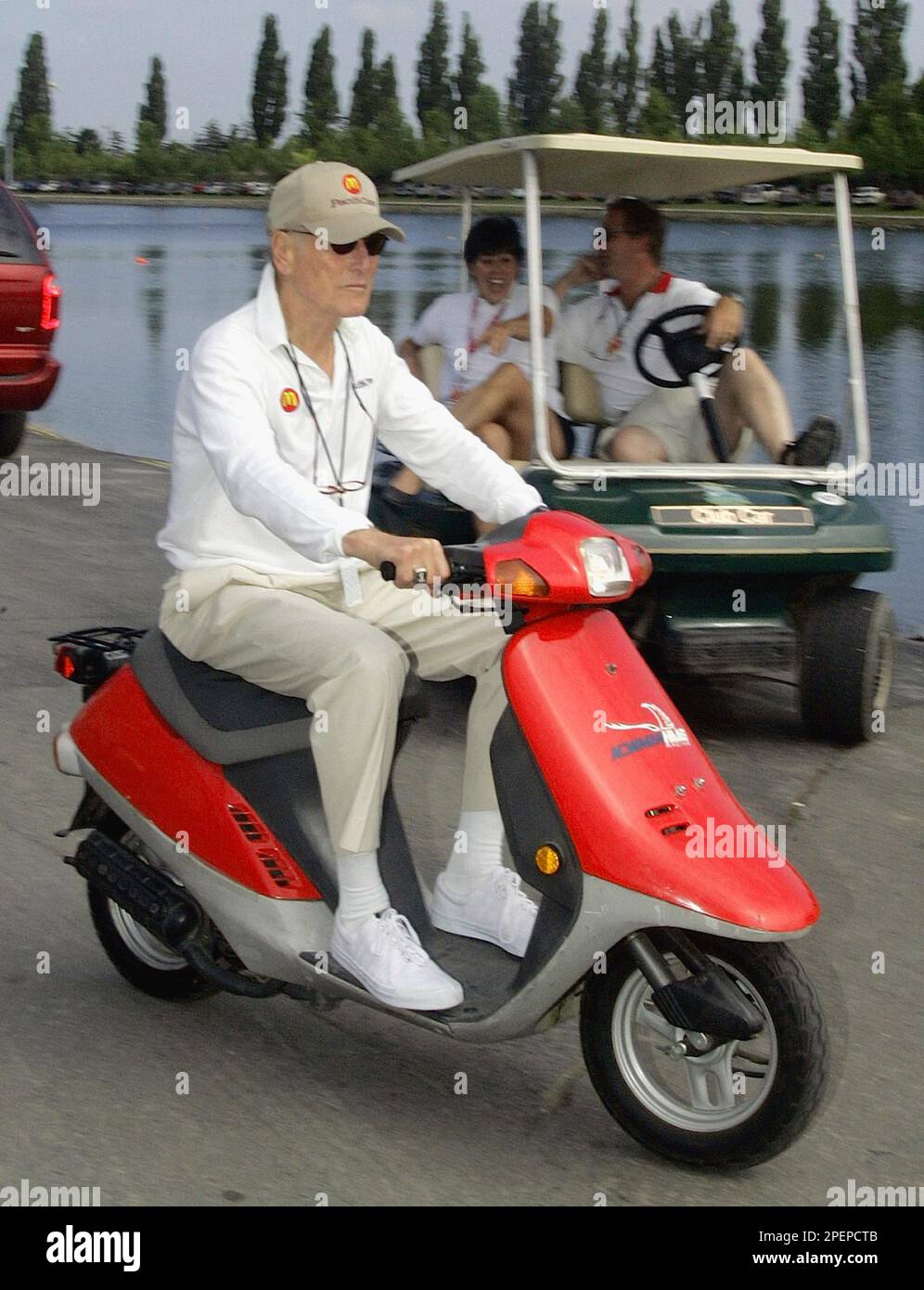 Team co-owner and actor Paul Newman drives his scooter after visiting ...