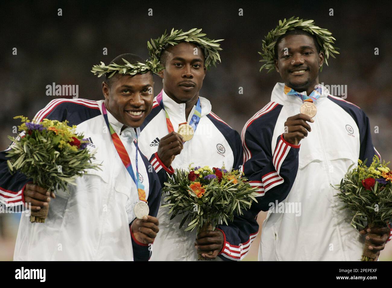 Men's 200 meter gold medalist Shawn Crawford, centre, is flanked by ...