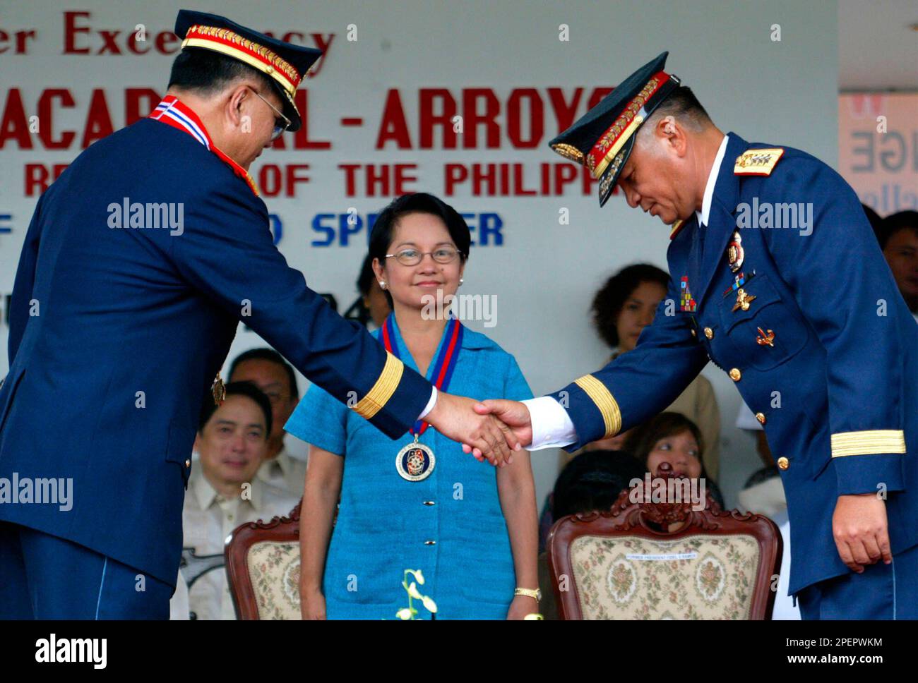 Philippine President Gloria Macapagal Arroyo (center) watches as ...