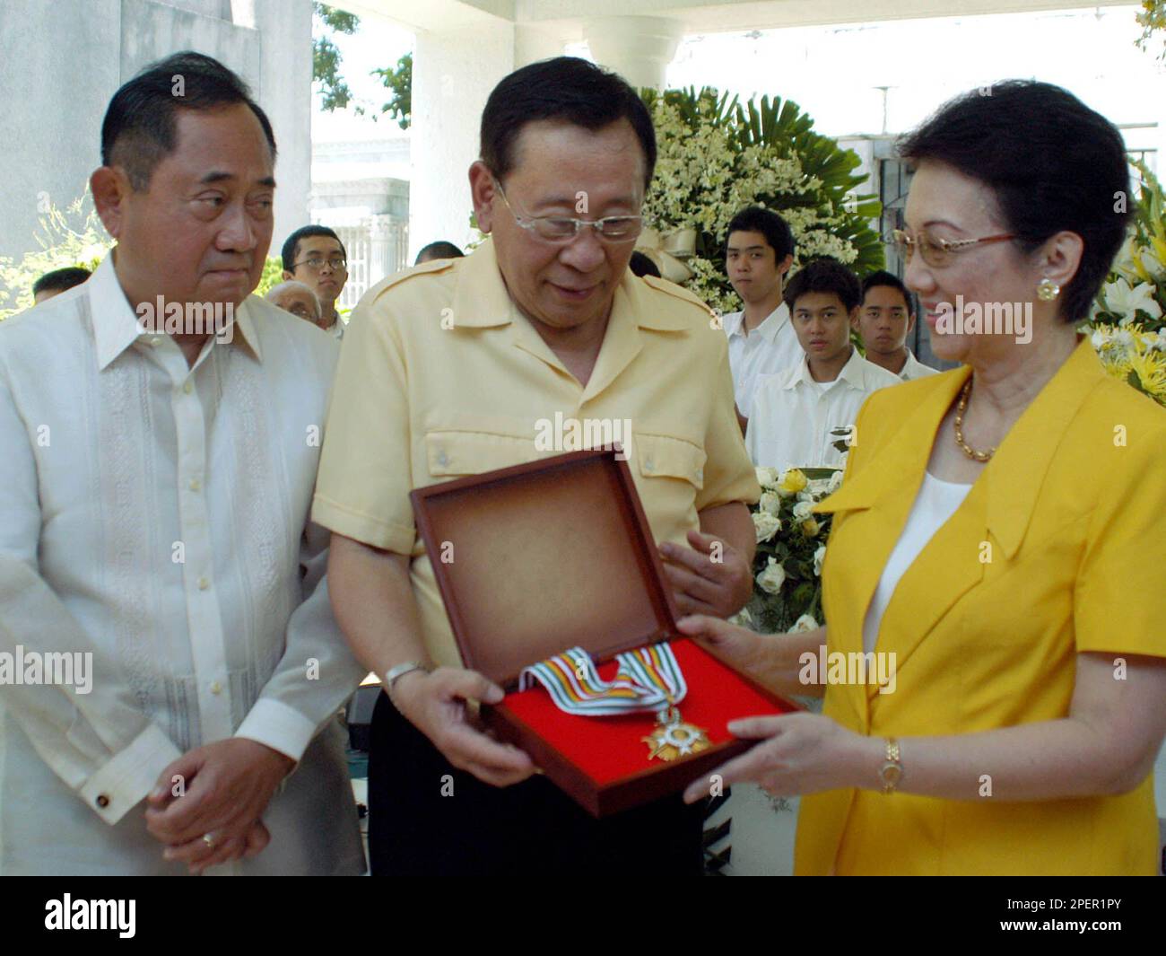 Former President Corazon Aquino, right, receives from House Speaker ...