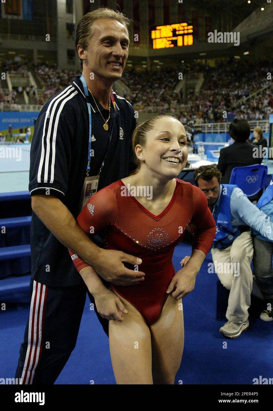 Carly Patterson, of the United States, right, is joined by her coach ...