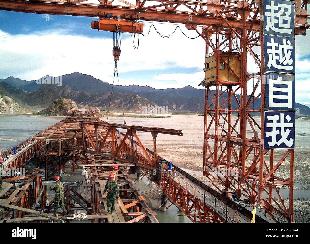 Construction workers assembles parts of the 928-meter-long (3,100-foot ...