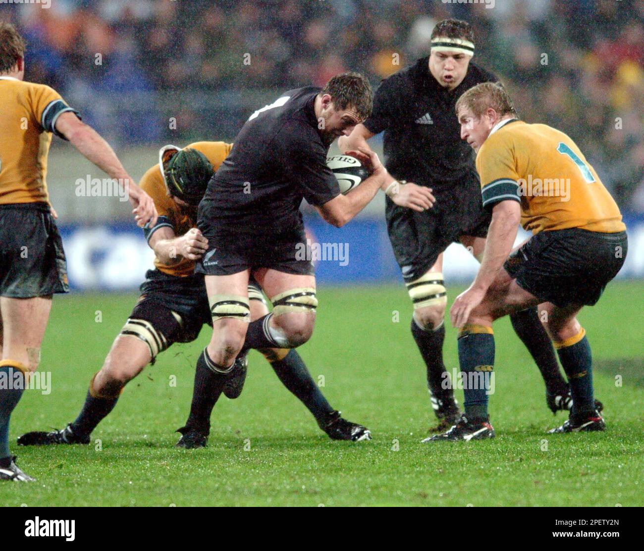 New Zealand All Blacks' Chris Jack, center, is tackled by Australian ...