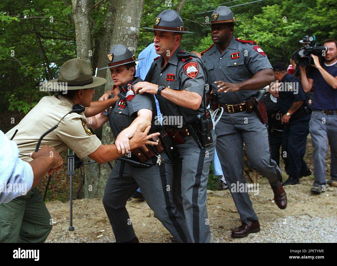 ** FILE ** Narragansett Tribe Environmental Police officer Thawn Harris, left, tries to hold ...