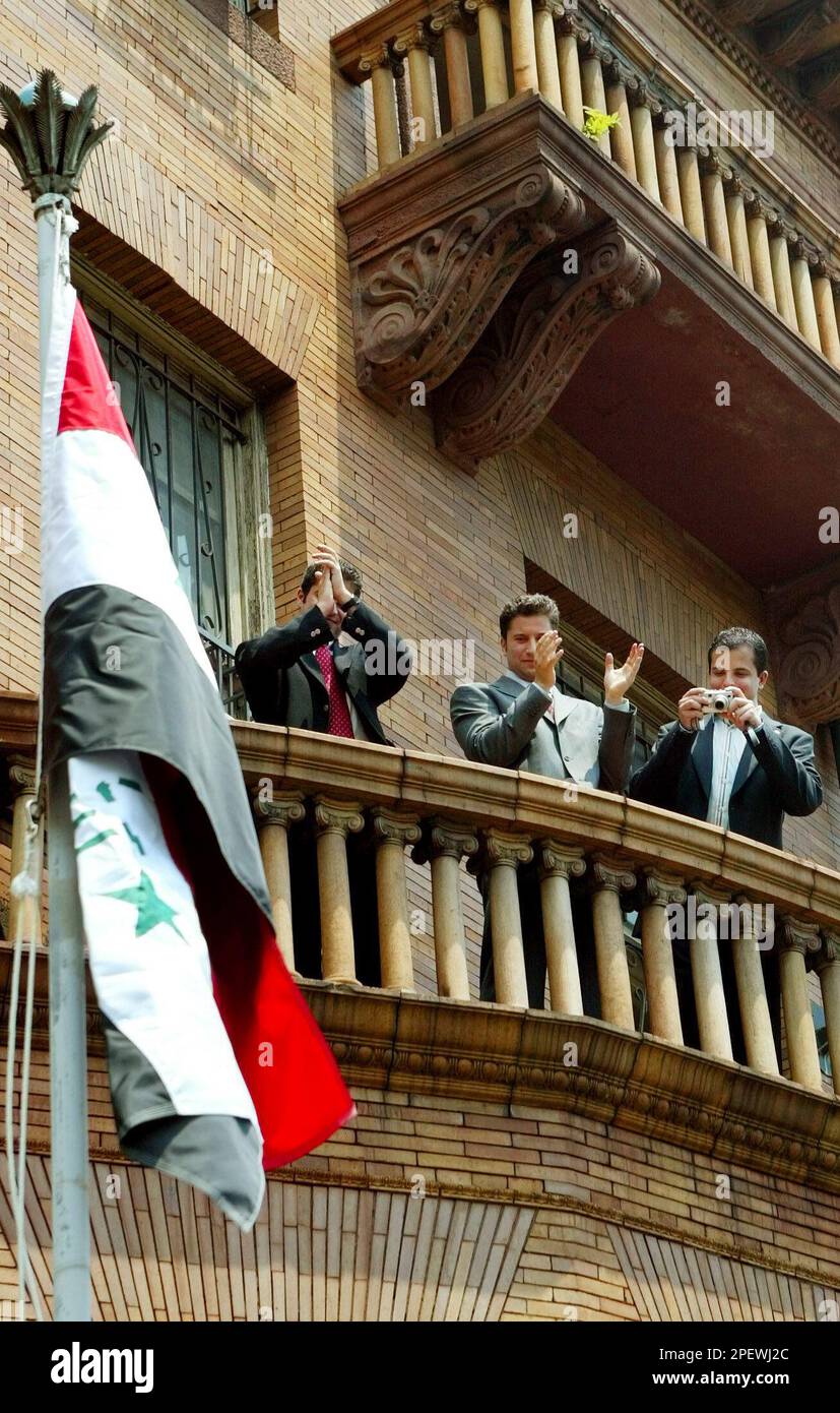 Guest of the newly re-opened Iraqi Embassy applaud during the flag ...