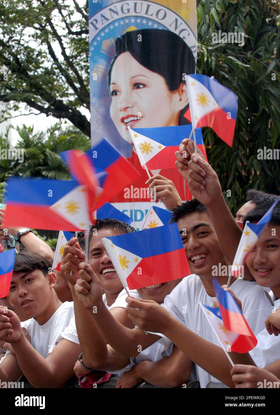A crowd of supporters wave Philippine flags as they cheer the inauguration of Philippine ...