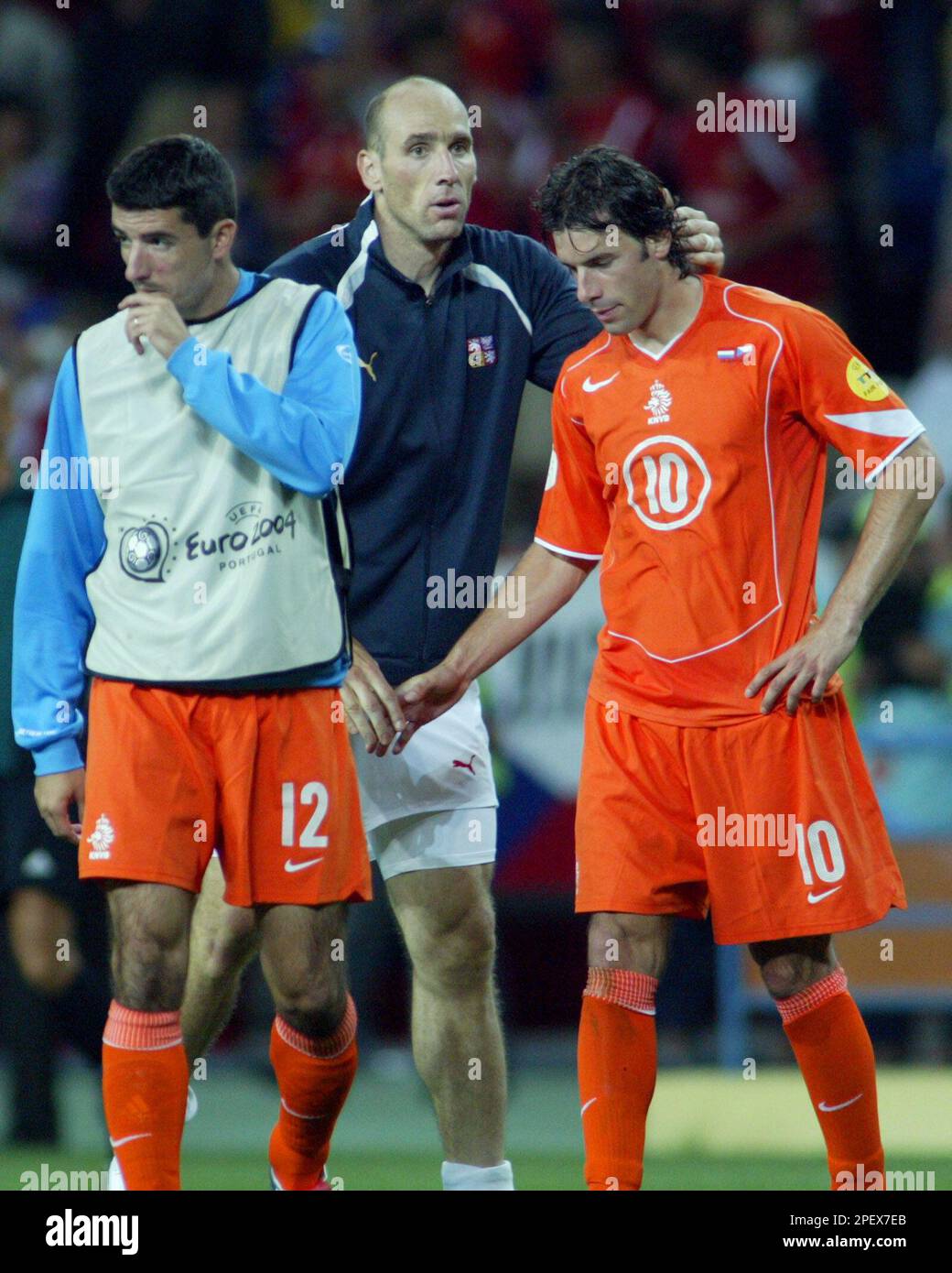 The Czech Republic's Jan Koller, center, consoles the Netherlands' Ruud ...